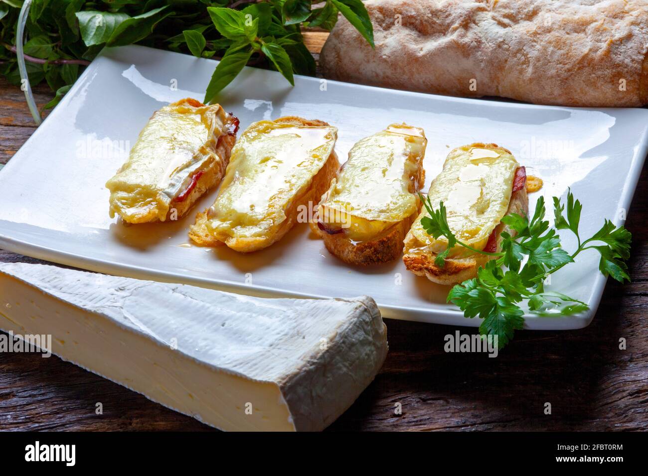 Melted brie cheese bruschetta food Stock Photo - Alamy