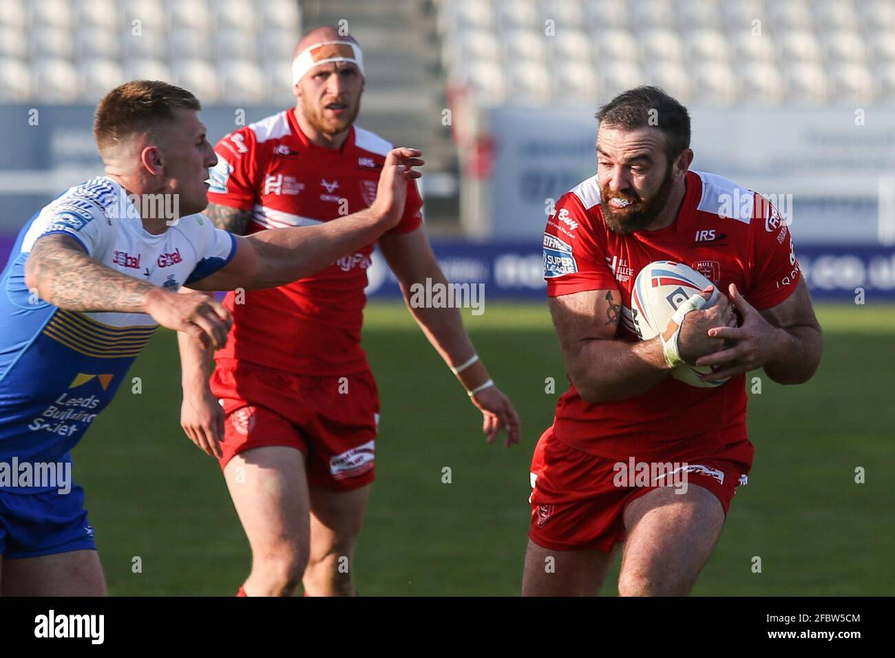 Kane Linnett (12) of Hull KR looks to go past Alex Mellor (11) of Leeds ...