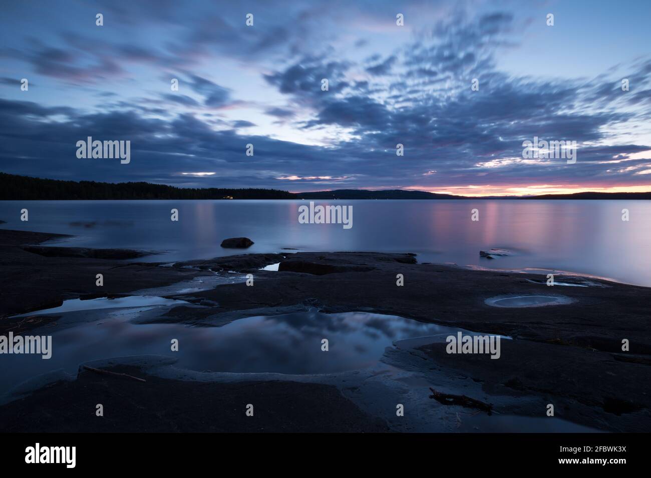 Beautiful twilight scene from a lake in sweden Stock Photo - Alamy
