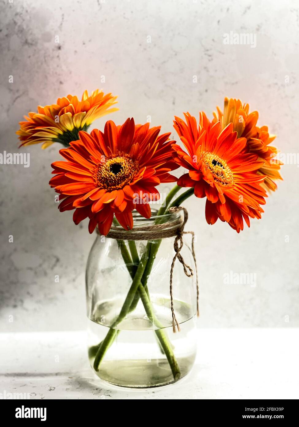 Bouquet of beautiful gerbera flowers in a glass vase Stock Photo - Alamy