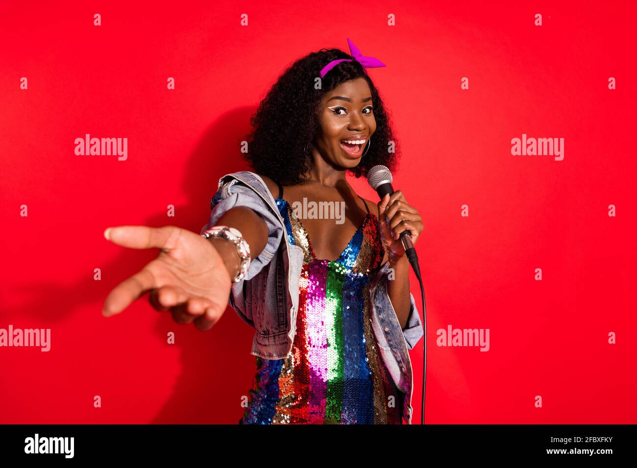 Female singer pointing to microphone hi-res stock photography and ...