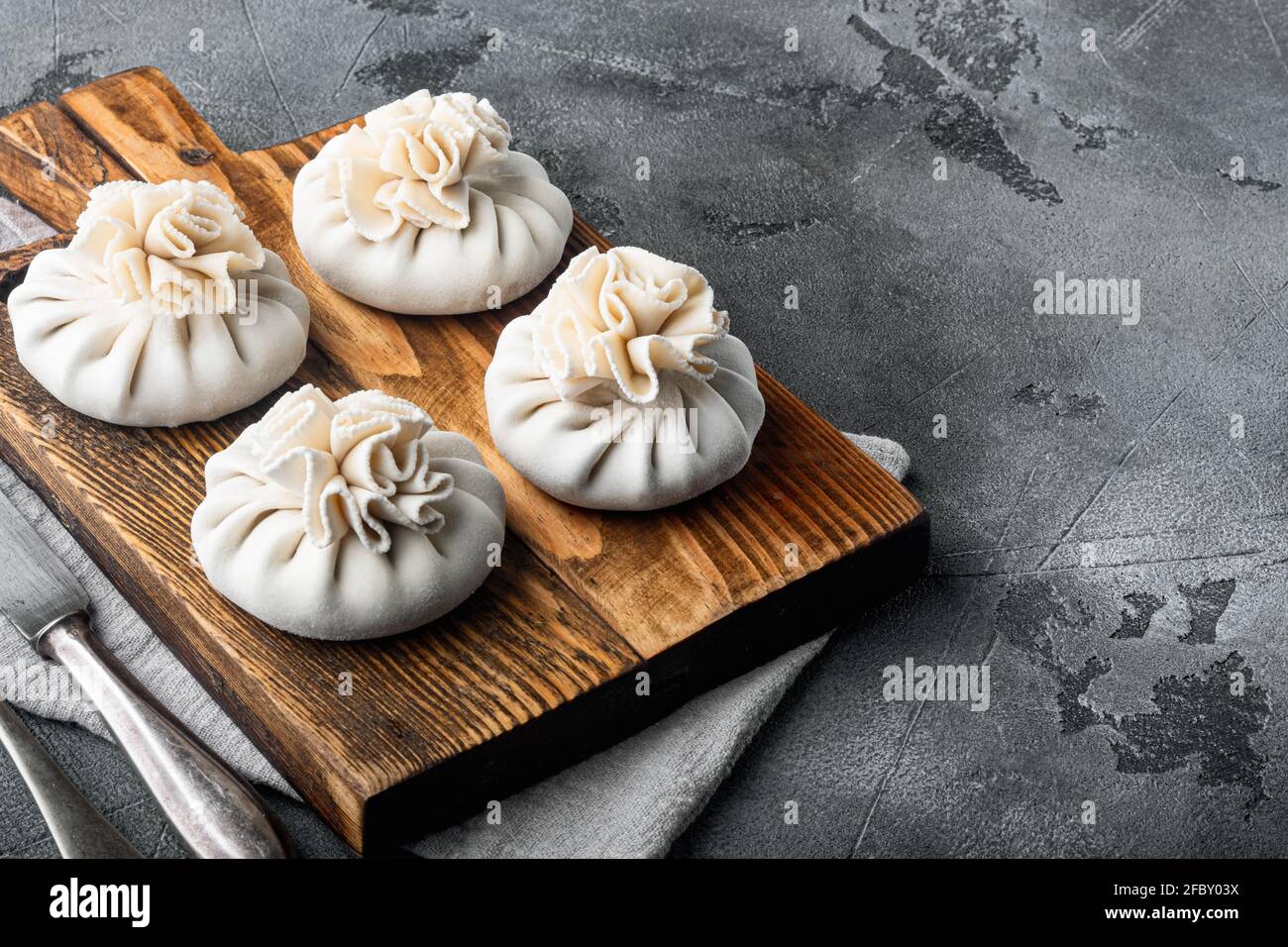 Homemade, traditional chinese pan fried dumplings set, on gray stone ...