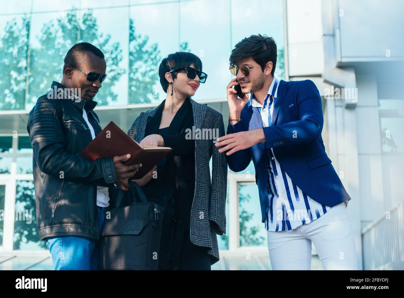 Three happy business colleagues talking outside the office Stock Photo ...