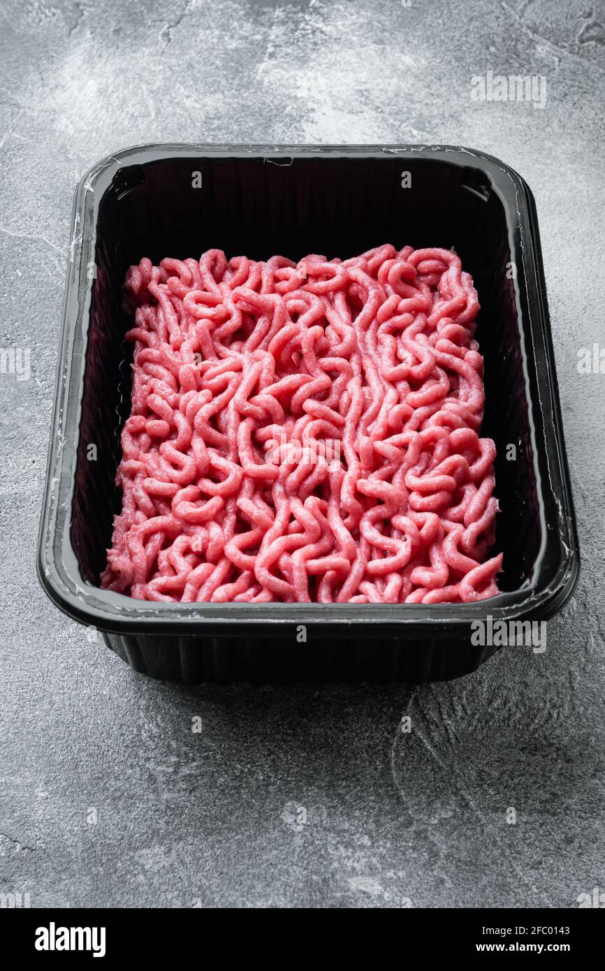 Minced meat in packaging set, on gray stone background Stock Photo - Alamy