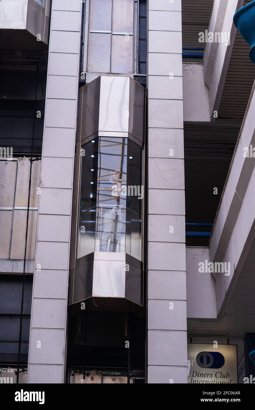 Handsome businessman is on his way to his office while going up with ...