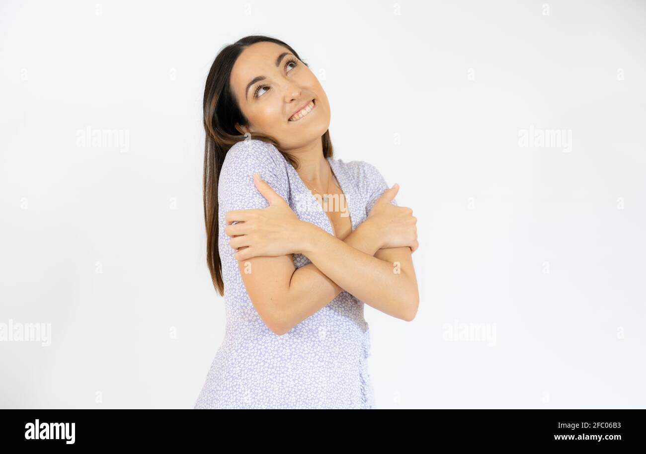 Young woman hugging herself isolated over white background Stock Photo ...
