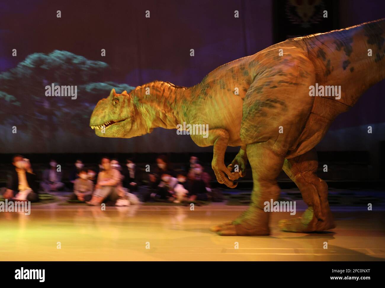 Tokyo, Japan. 23rd Apr, 2021. An actor wearing dinosaur-shaped ...