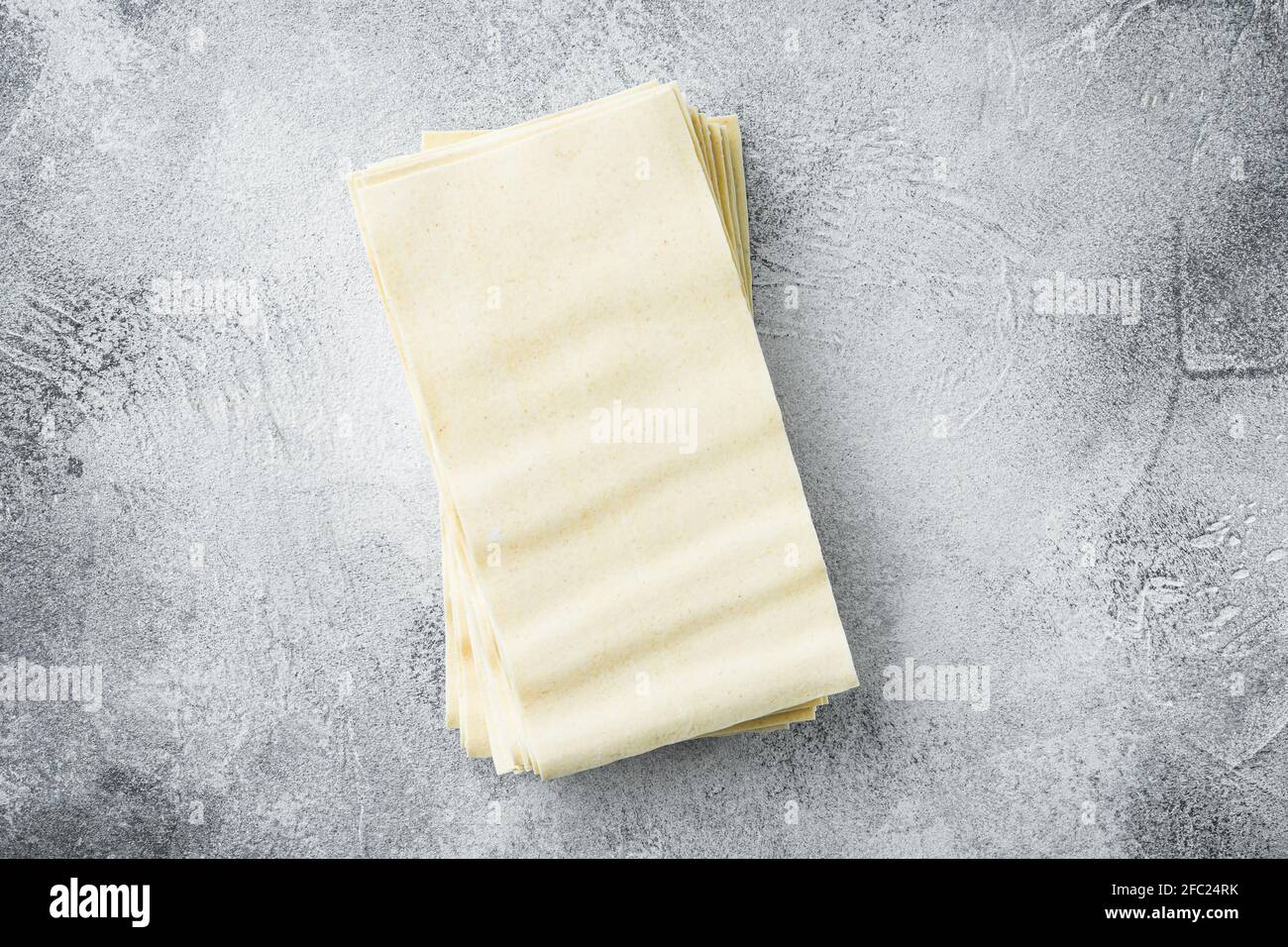 Dried uncooked lasagna pasta sheets set, on gray stone background, top ...