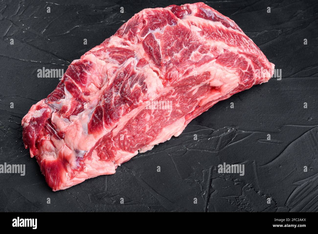 Raw rib eye beef steak marbled meat whole cut set, on black stone ...