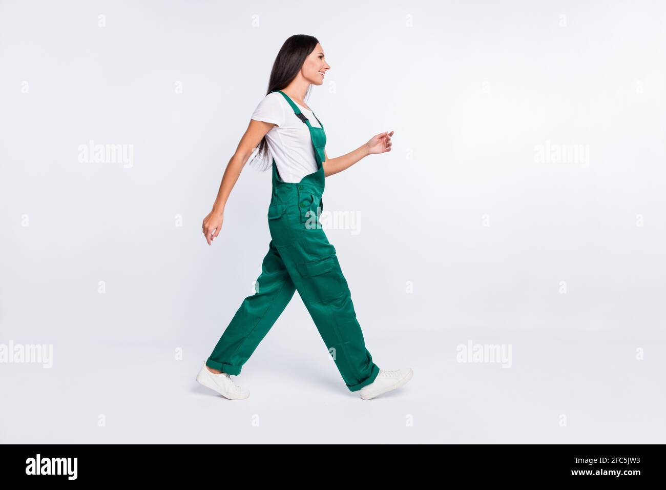 Profile photo of positive pretty lady step wear green overall sneakers ...