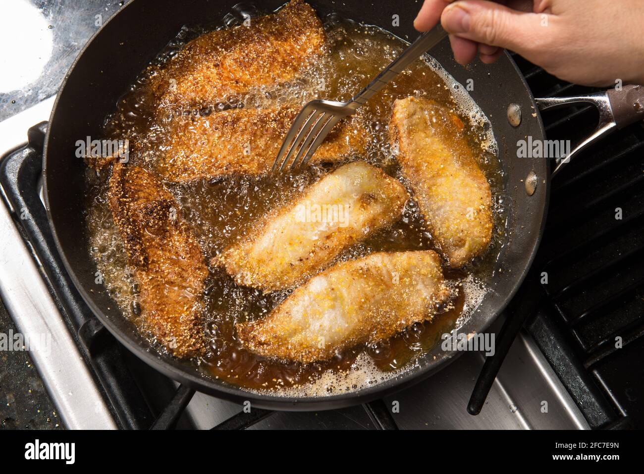 Female cooking fish hi-res stock photography and images - Alamy