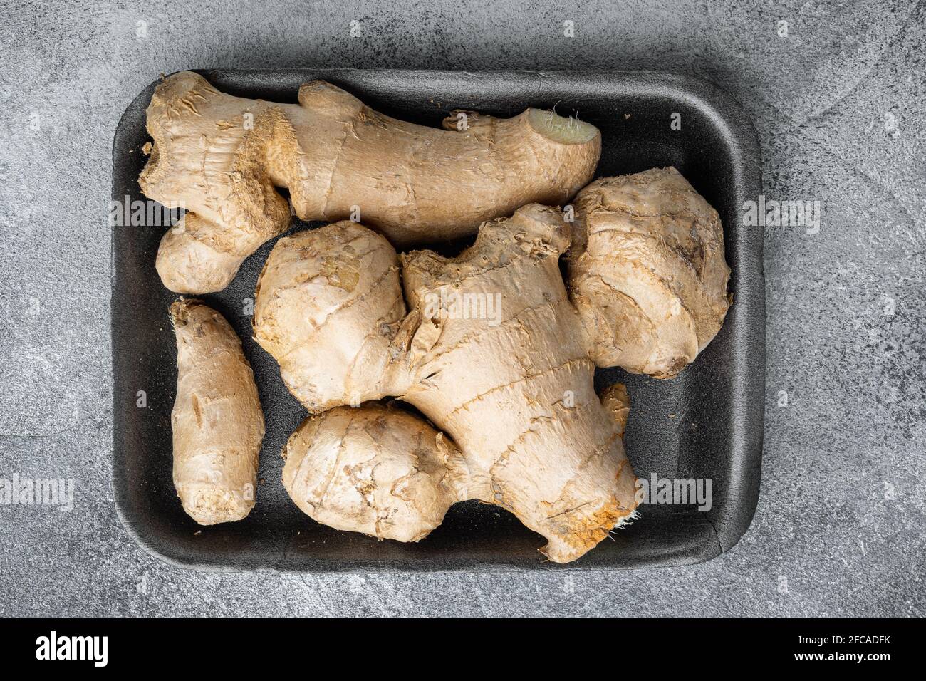 Fresh organic ginger on fresh market set, in plastic market container ...