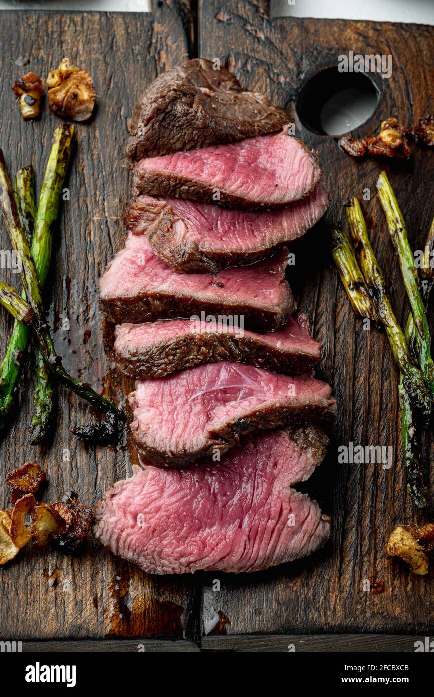 Medium rare beef steak set, tenderloin or fillet mignon cut, on wooden ...
