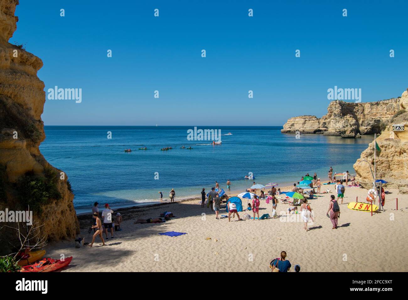 People on the beach enjoying the summer in Algarve Marinha Beach at ...