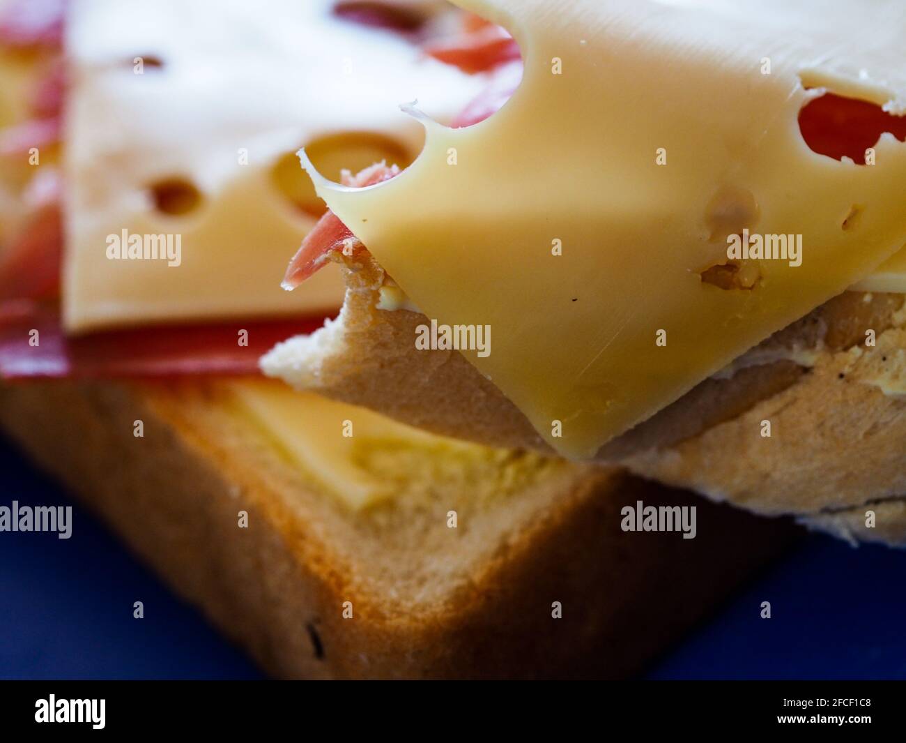 Food, prosciutto and holey cheese on bread ready to eat, yum! Stock ...