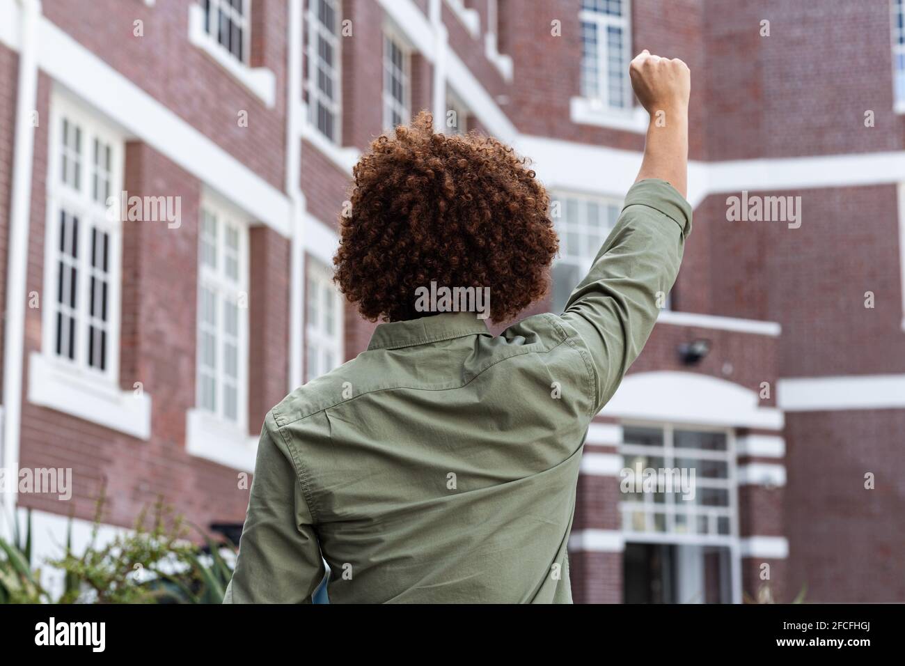 Back view of mixed race man raising fist Stock Photo - Alamy