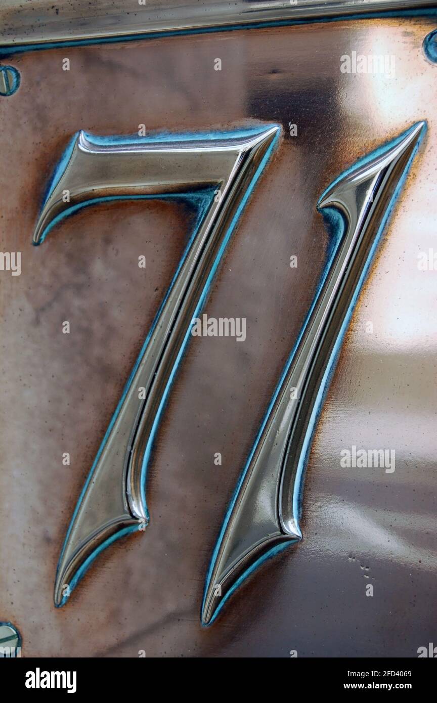 The number seventy one (71) embossed on a copper plate and on public ...