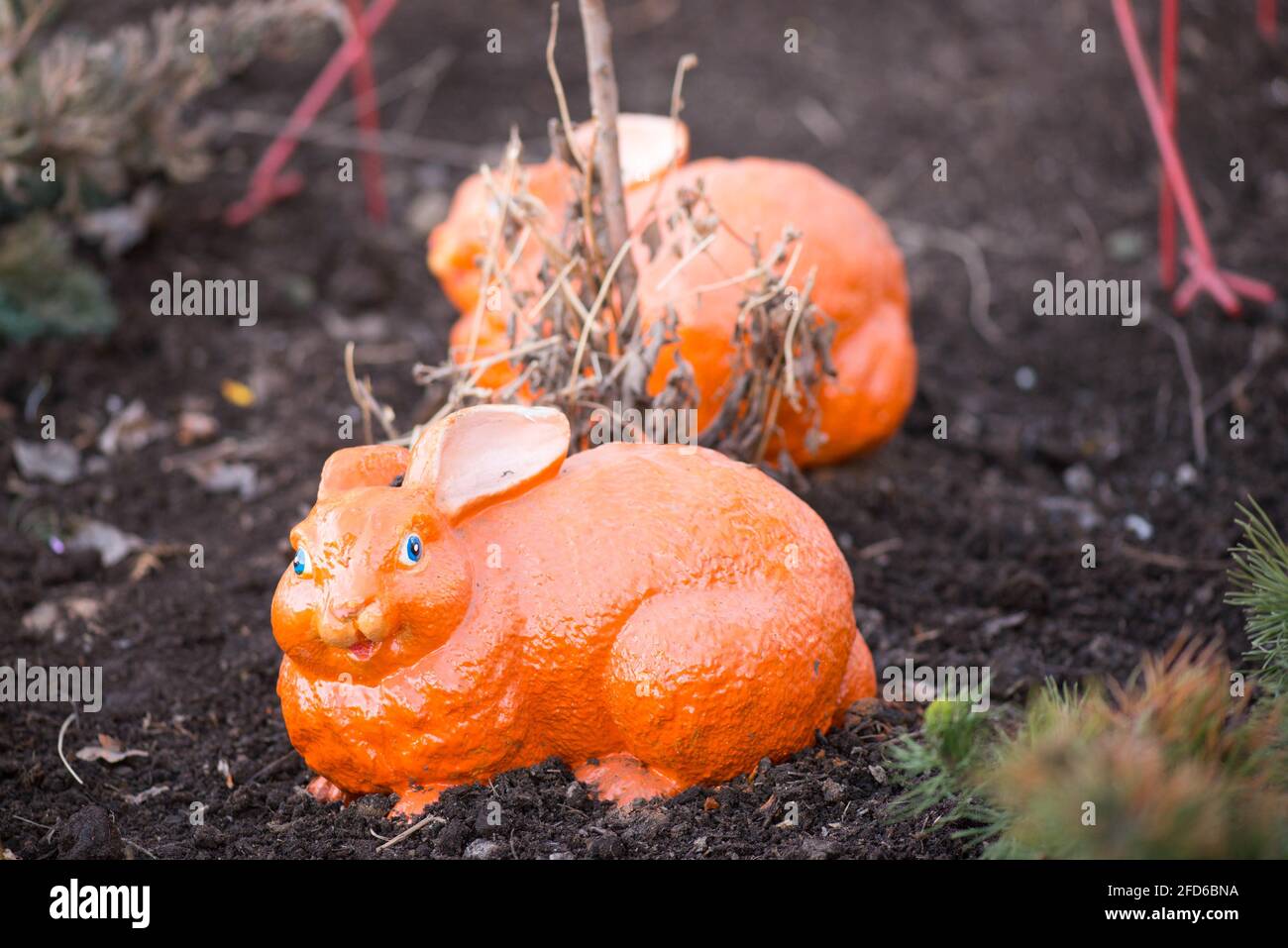 orange rabbit as decor sitting by the store Stock Photo - Alamy
