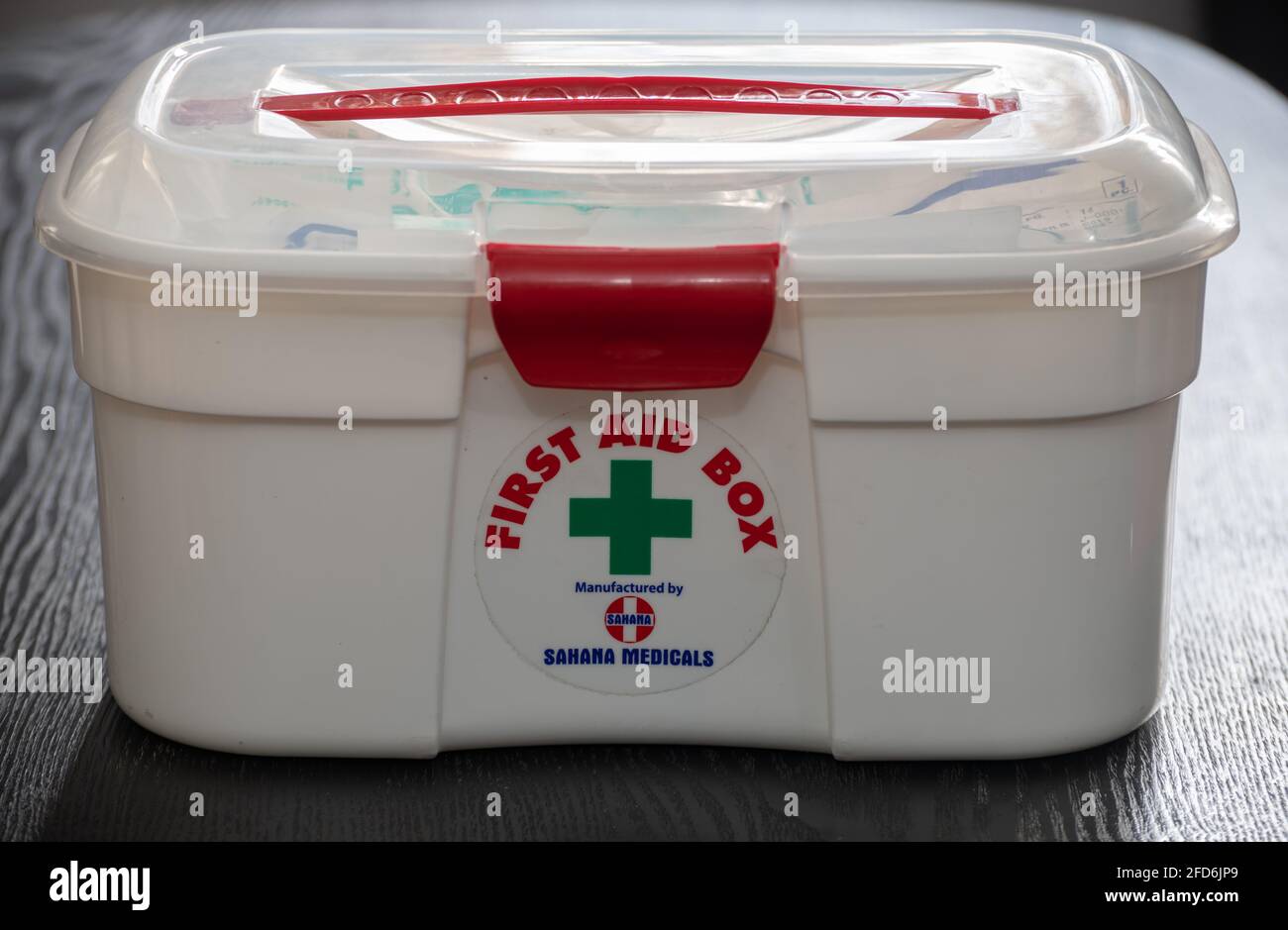 First aid box on a green-clothed tabletop front view close-up image ...