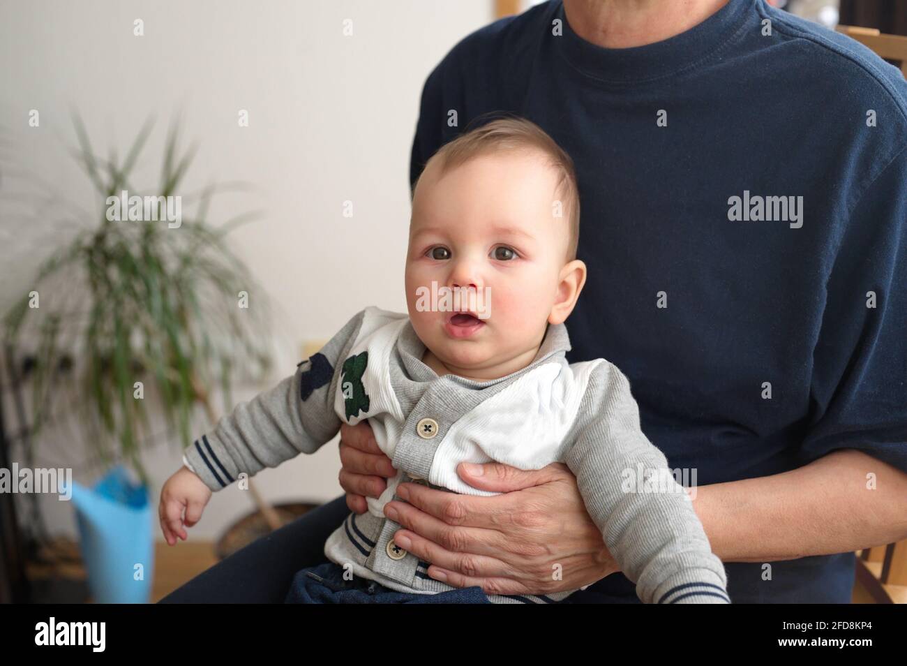 Grandmother cuddling baby hi-res stock photography and images - Alamy