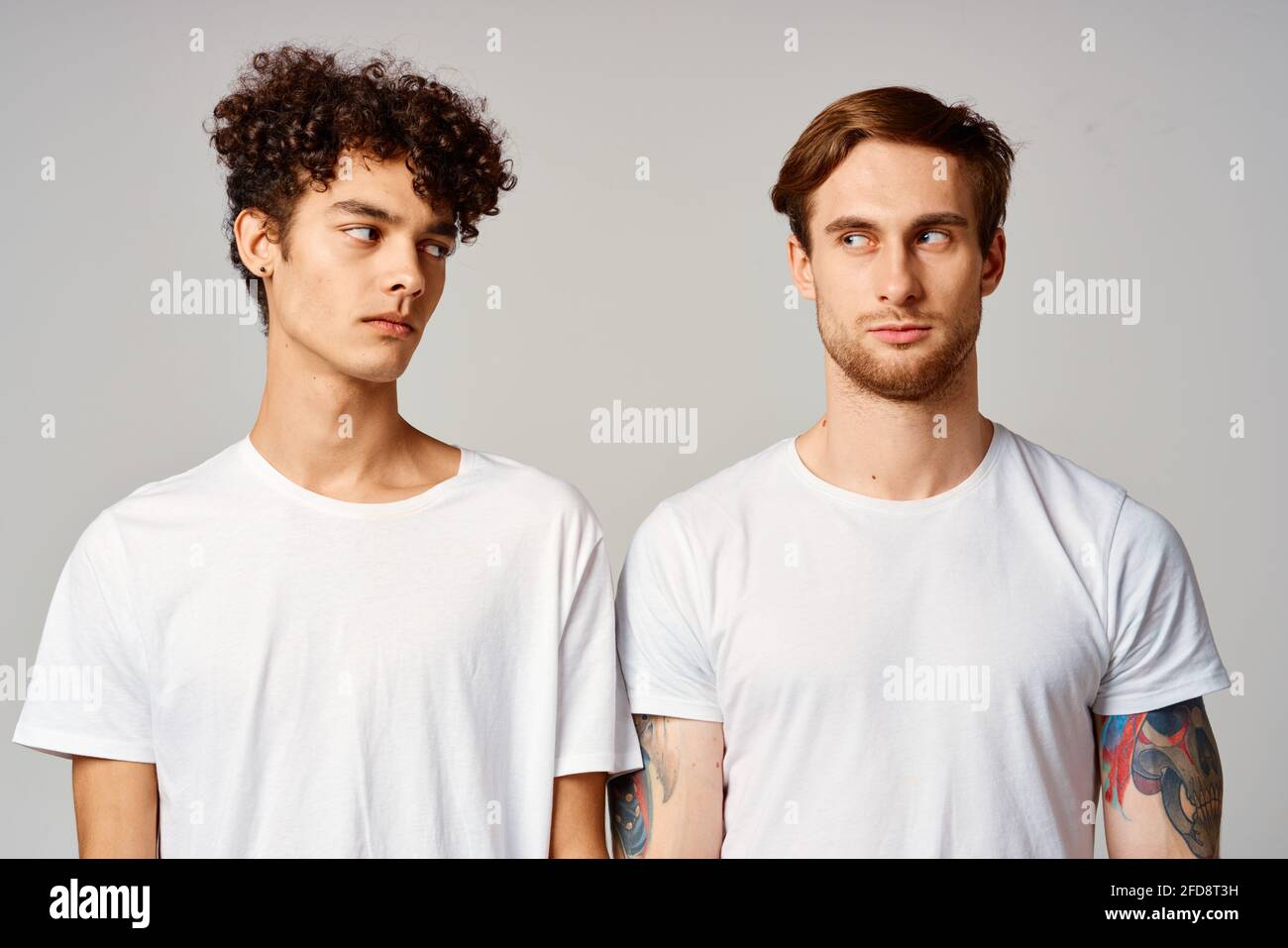 two men in white t-shirts are standing next to friendship emotions ...