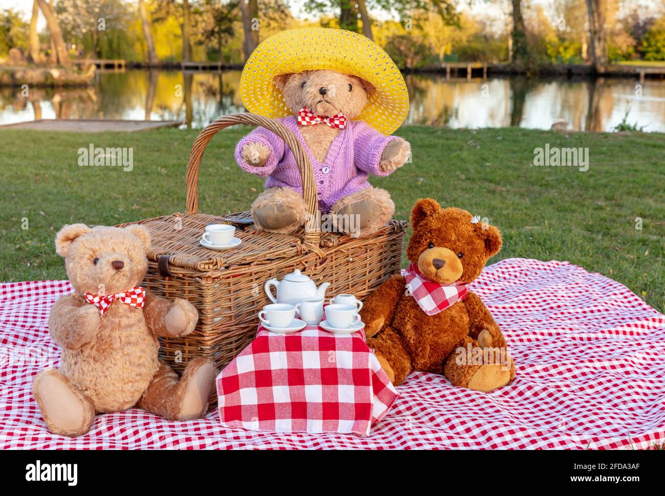 Teddy Bear's picnic with a lakeside setting. Three teddy bears having ...