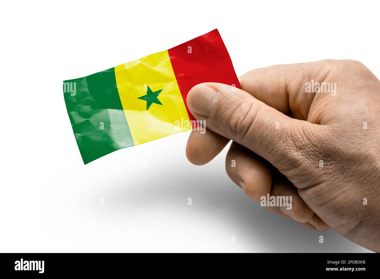 Hand holding a card with a national flag the Senegal Stock Photo - Alamy