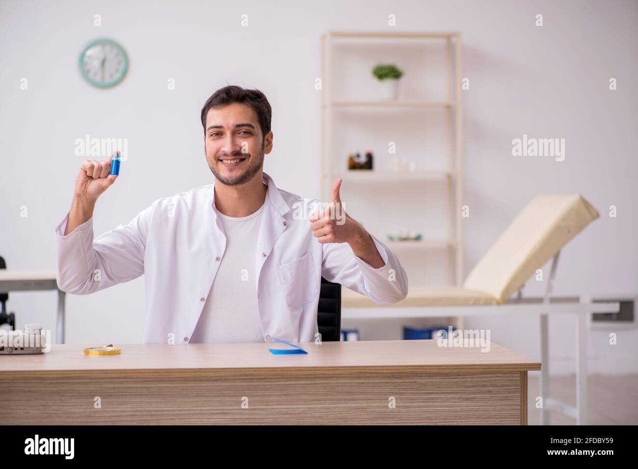 Young male chemist doctor holding vial at the lab Stock Photo - Alamy