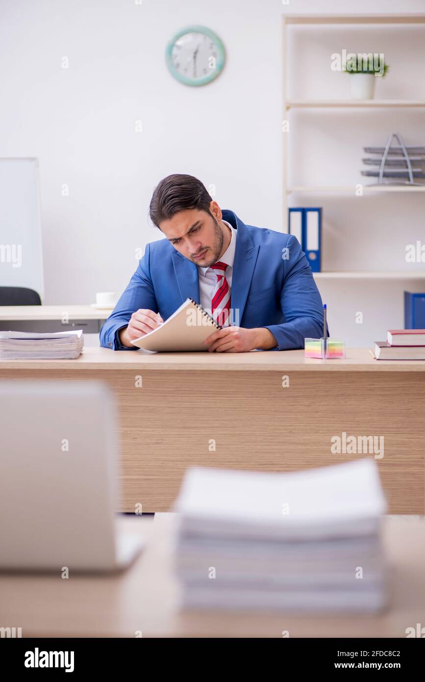 Young male employee working in the office Stock Photo - Alamy