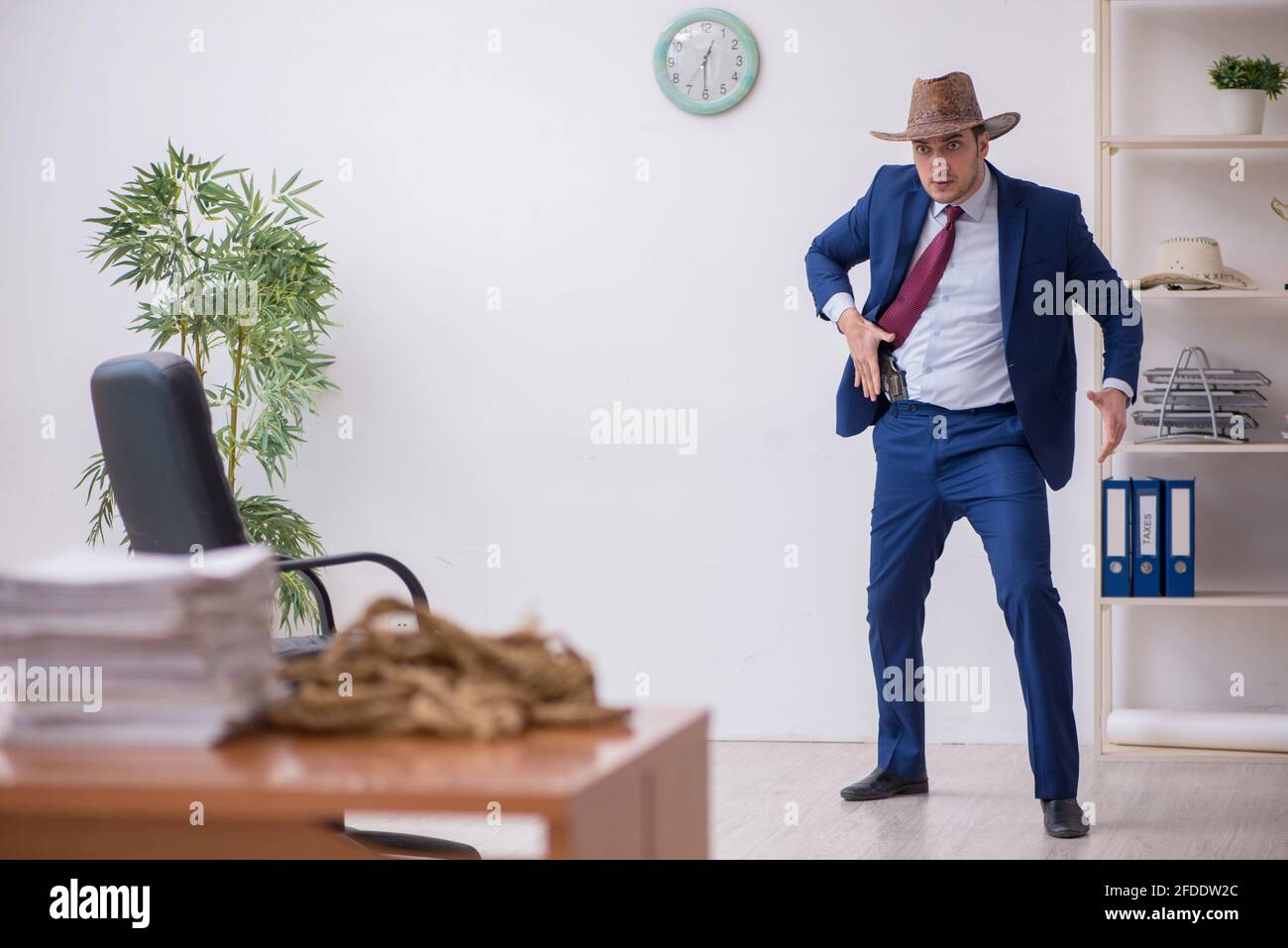 Young cowboy employee working at workplace Stock Photo - Alamy