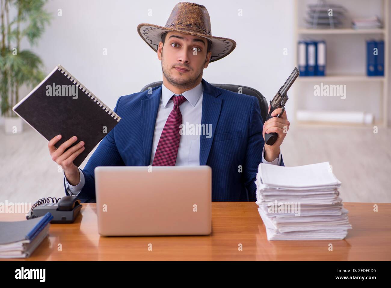 Young cowboy employee working at workplace Stock Photo - Alamy