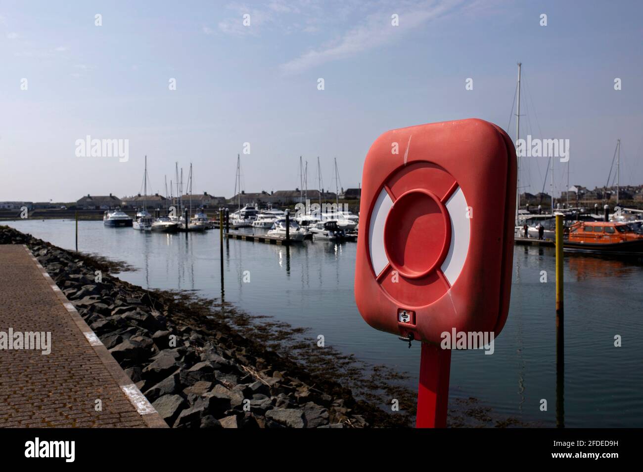 Life saving emergency floatation ring in a case on the side of a marina ...