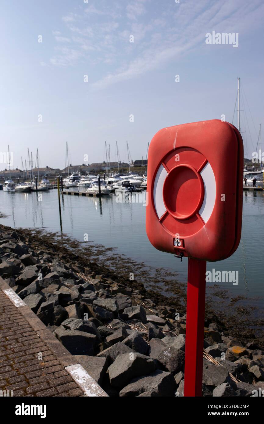 Life saving emergency floatation ring in a case on the side of a marina ...