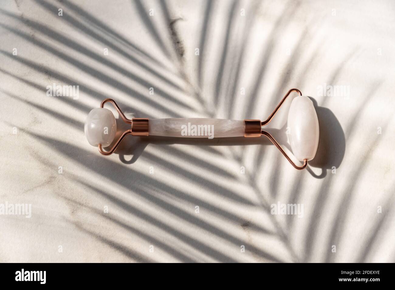 Rose quartz face roller for beauty facial massage therapy. Skin care ...