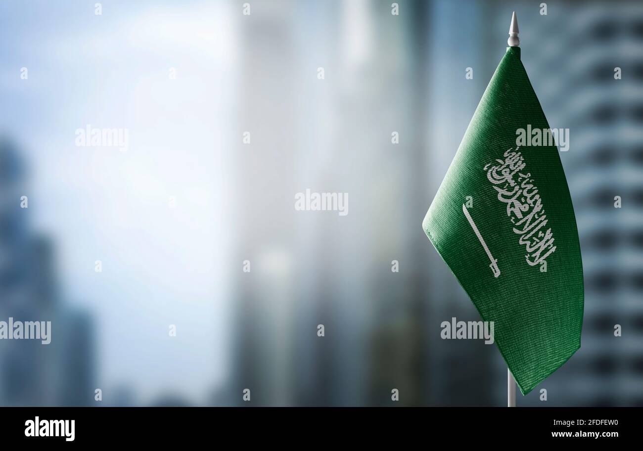 A small flag of Saudi Arabia on the background of a blurred background ...