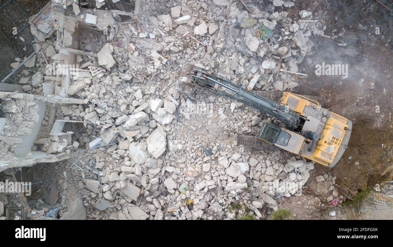 Excavator demolishing barracks for new construction project Stock Photo ...