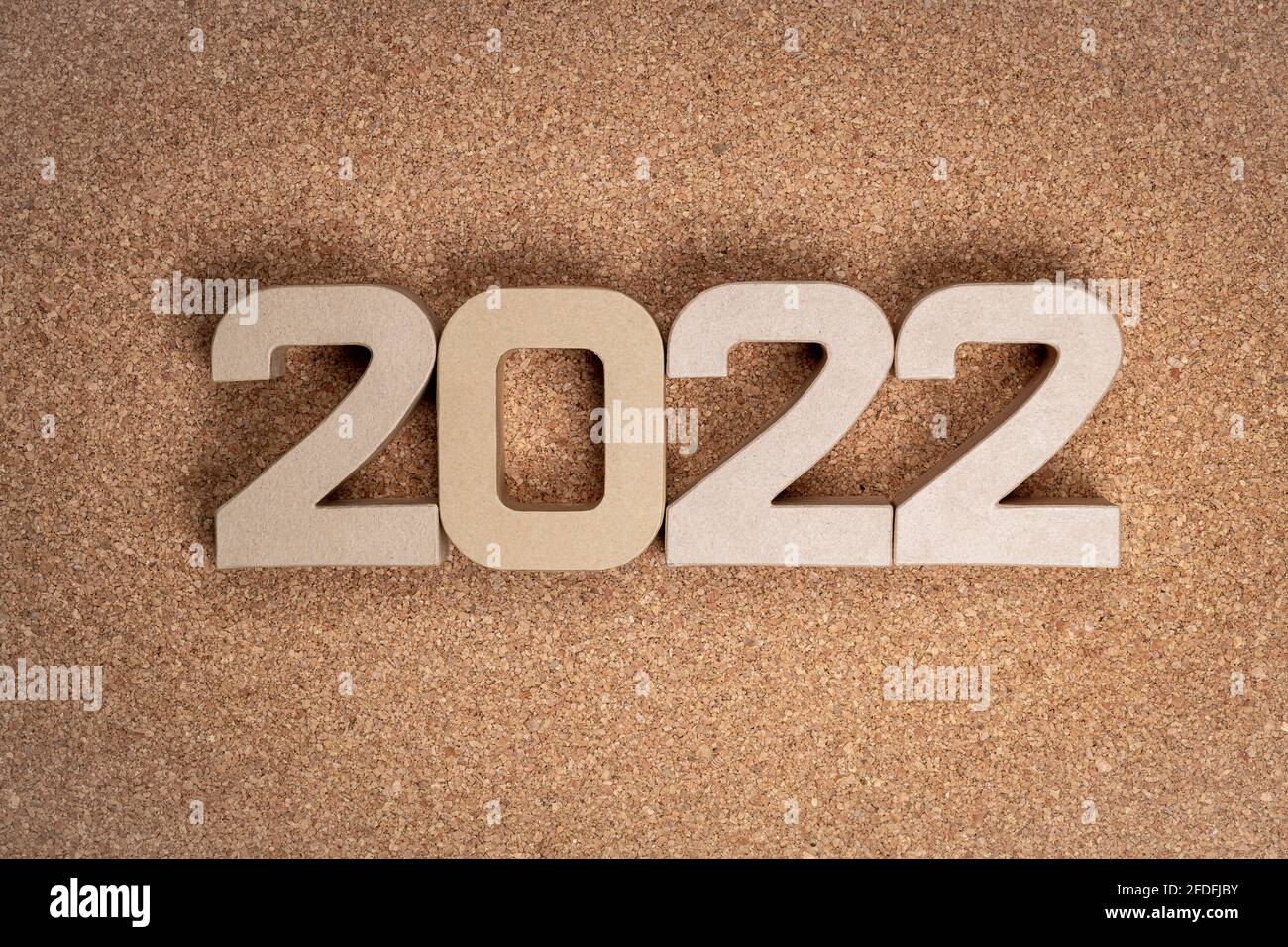 The year twenty twenty-two in large cardboard numbers on a cork ...