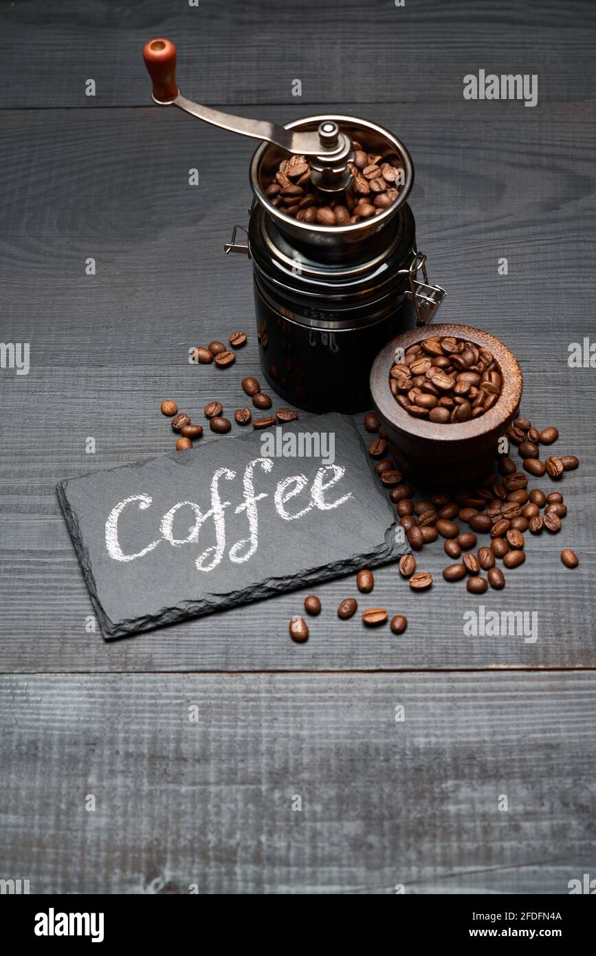 Coffee handwritten inscription sign on chalk board, coffee grinder and ...