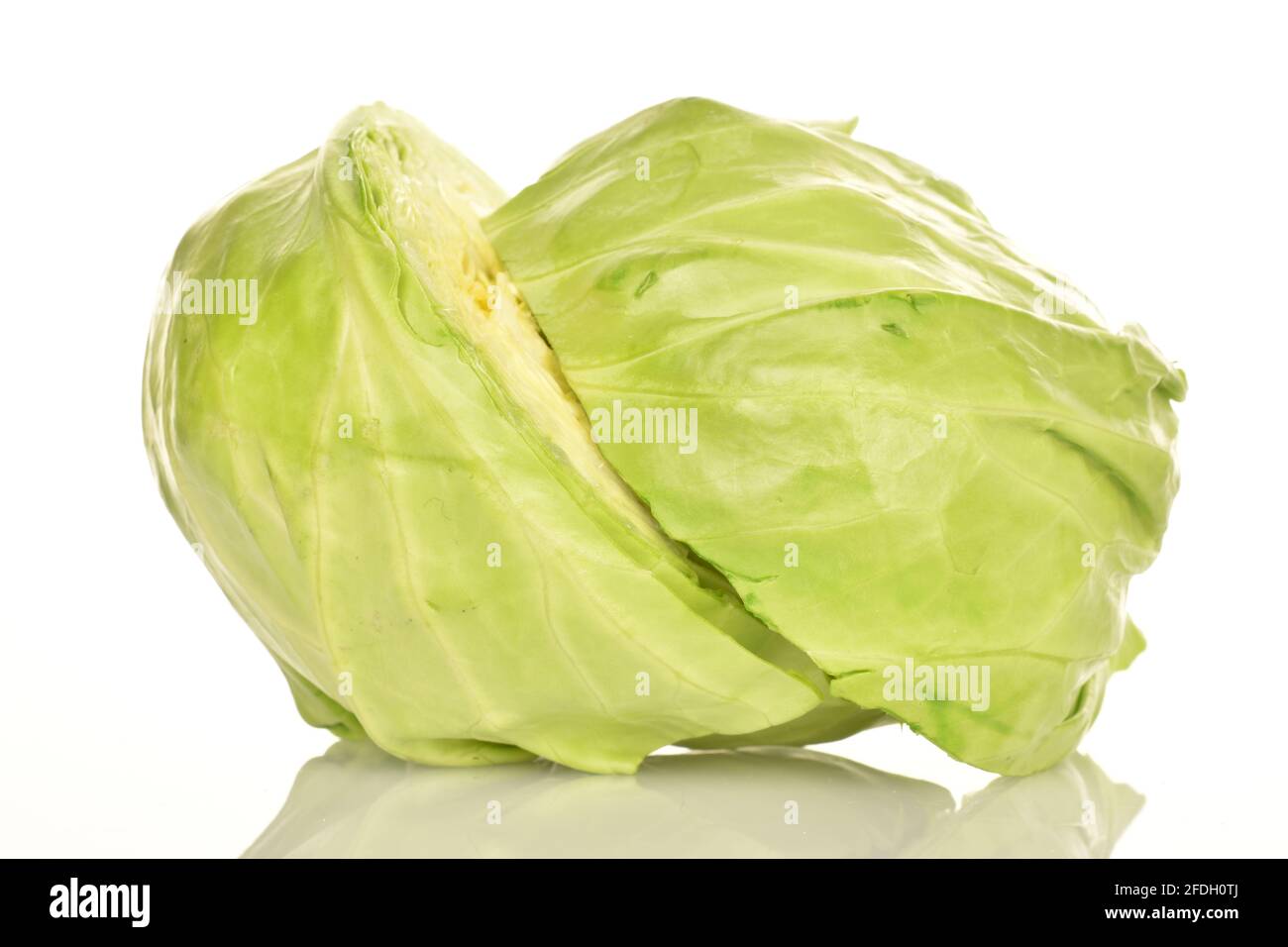 Two halves of fresh natural cabbage, closeup, on a white background ...