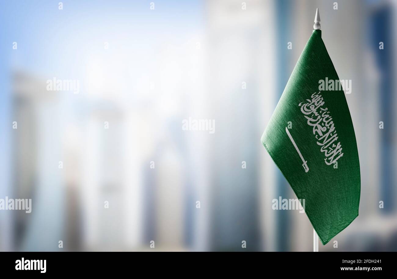 A small flag of Saudi Arabia on the background of a blurred background ...