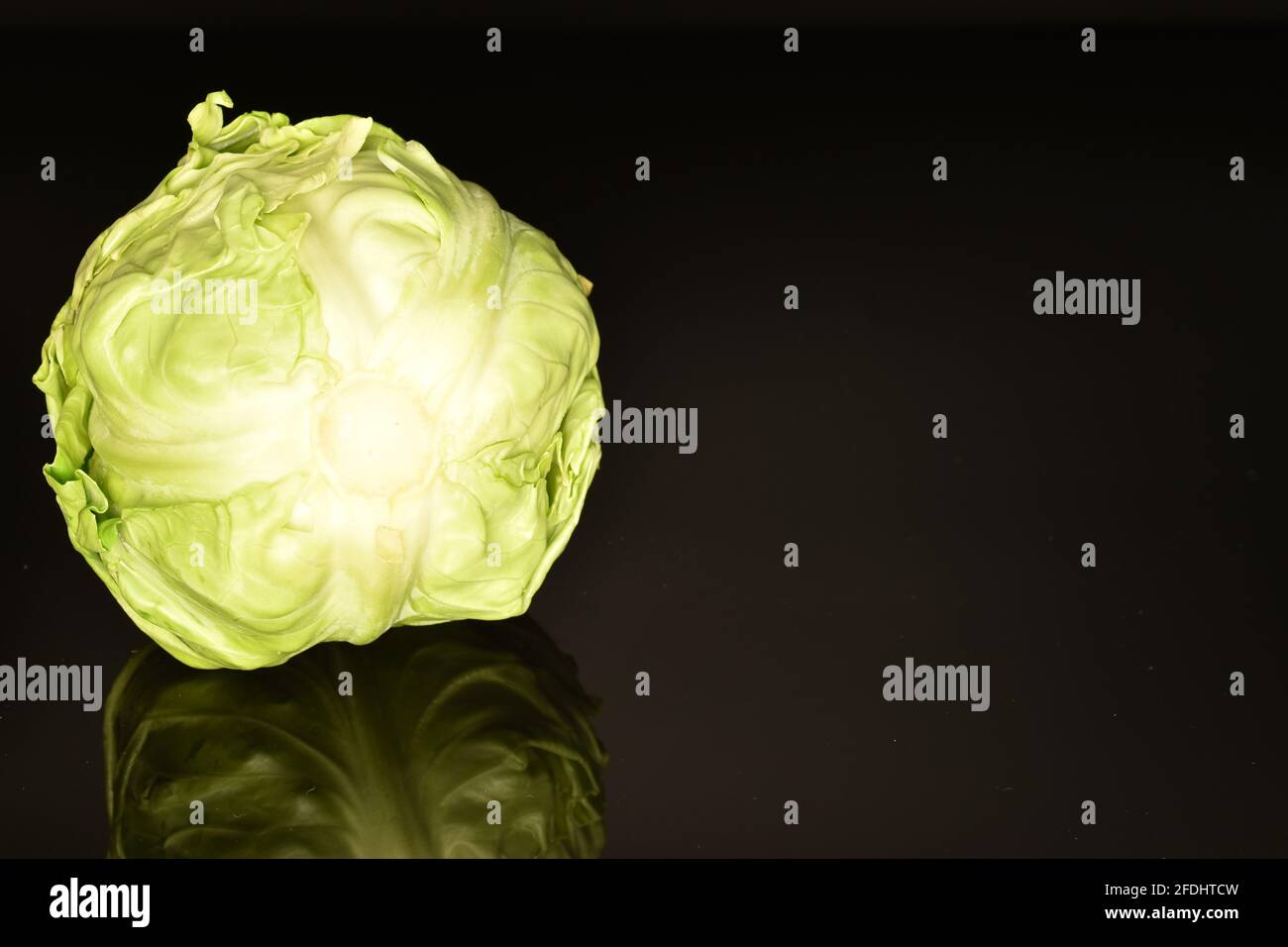 One fresh head of cabbage, close-up, on a black background Stock Photo ...