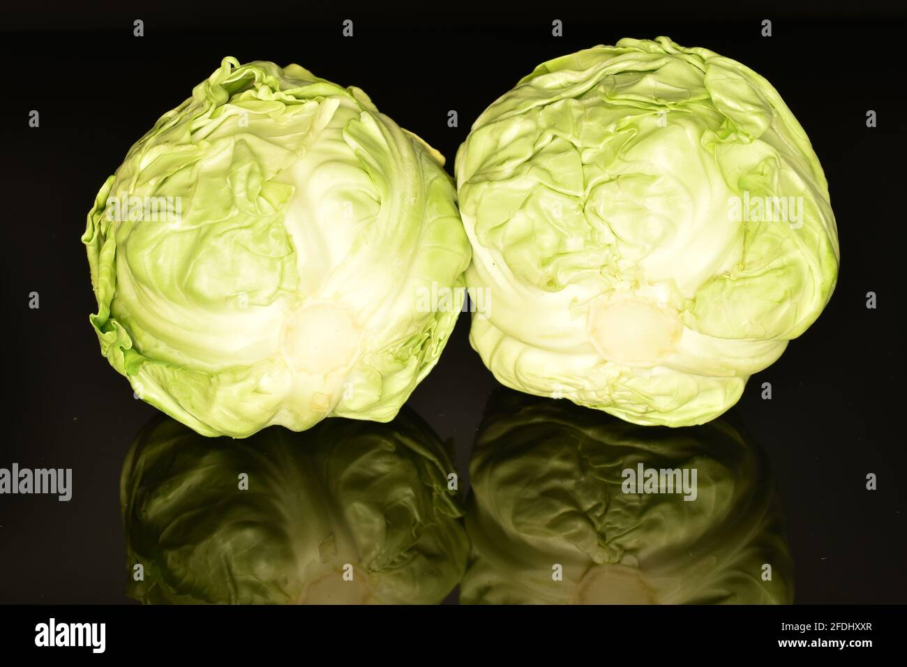 Two natural juicy heads of cabbage, close-up, isolated on black Stock ...