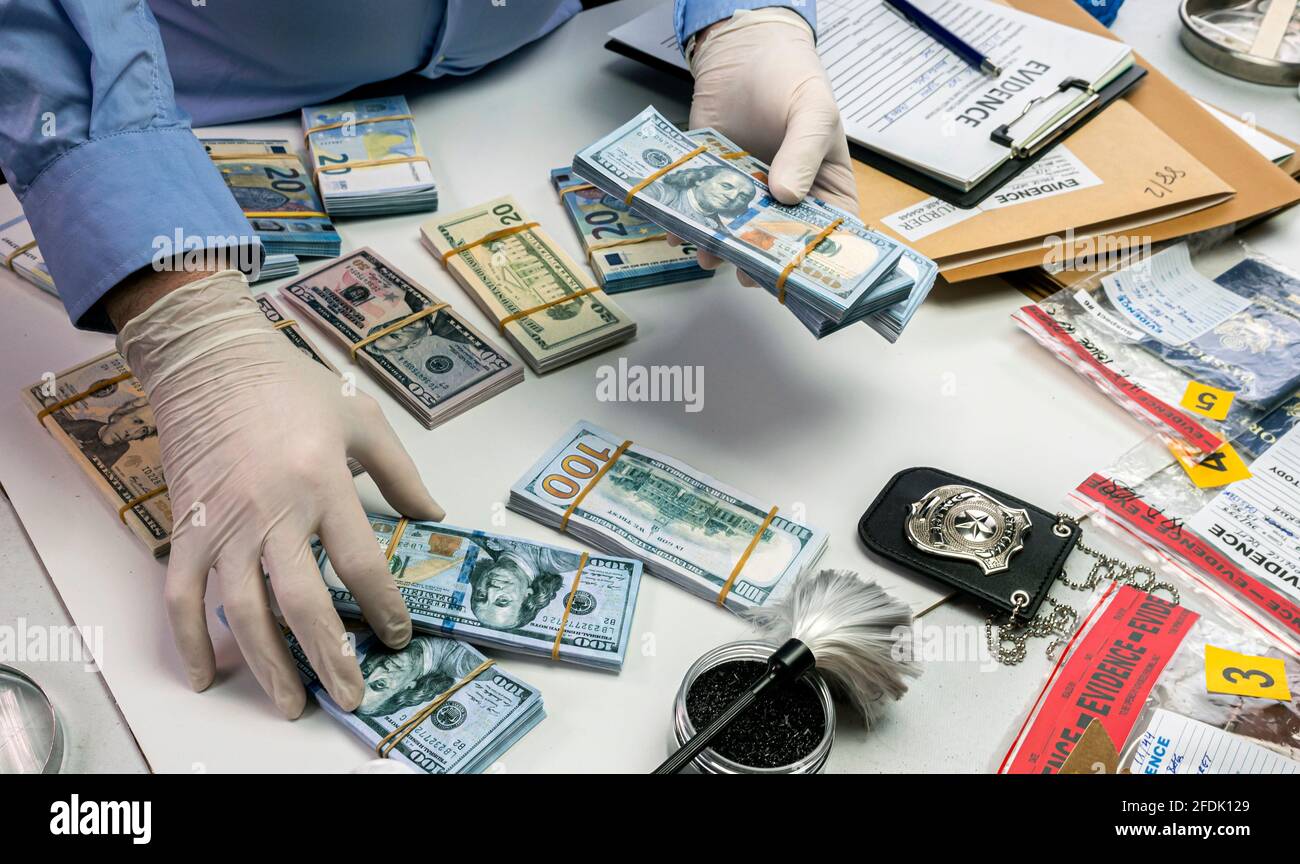 Specialised police officer notes dollar banknote reference of a robbery ...