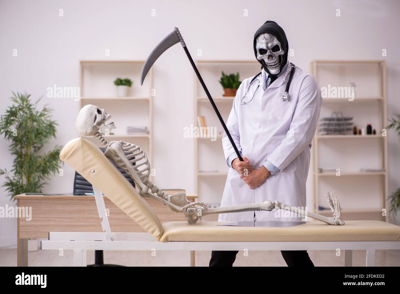 Reaper grim doctor examining skeleton patient in the clinic Stock Photo ...