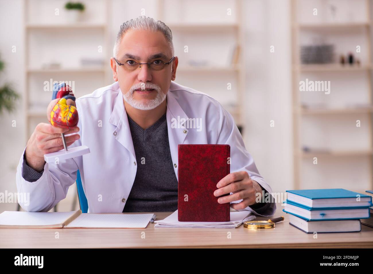 Old doctor cardiologist sitting in the classroom Stock Photo - Alamy