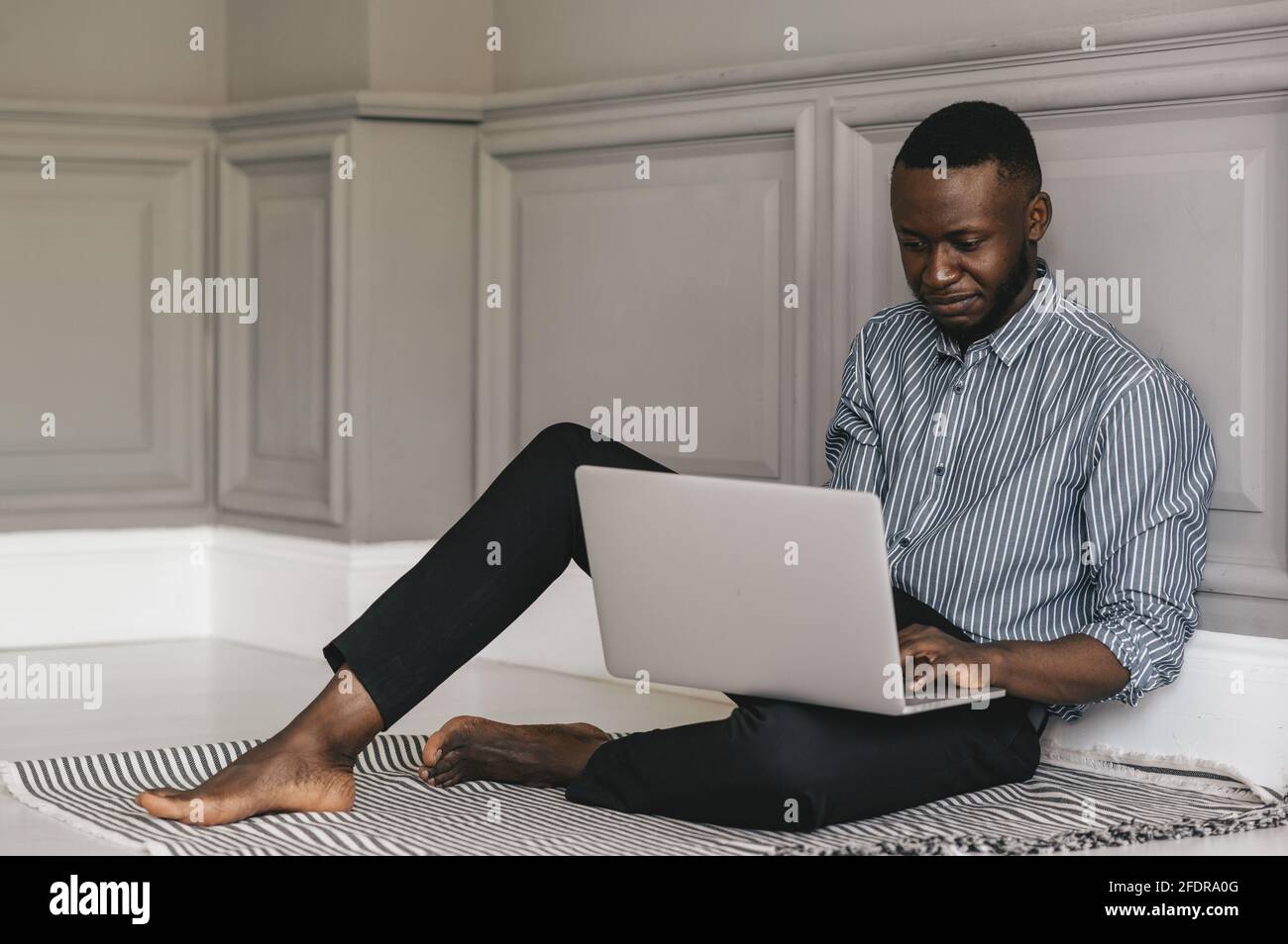 serious black male student looking at laptop listening lecture study ...