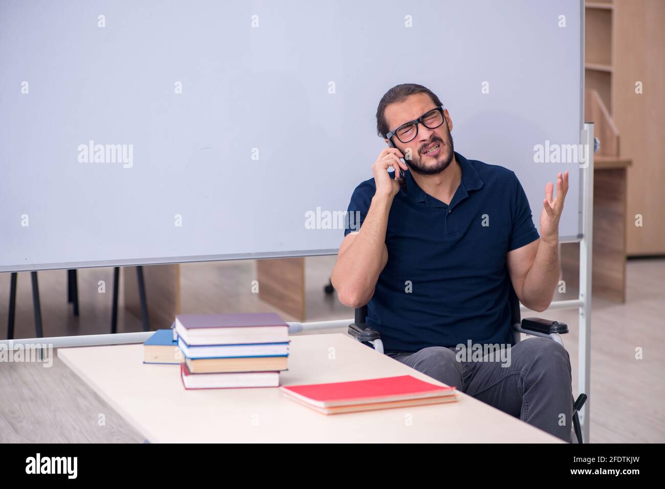 Young handicapped student in the classroom Stock Photo - Alamy