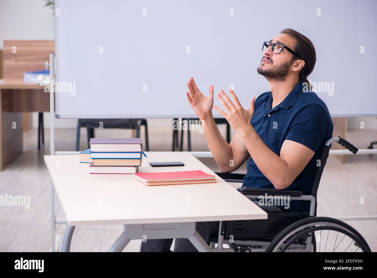 Young handicapped student in the classroom Stock Photo - Alamy