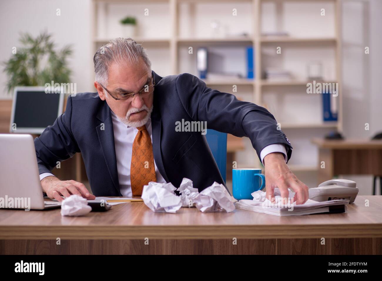 Old employee in paper recycling concept Stock Photo - Alamy