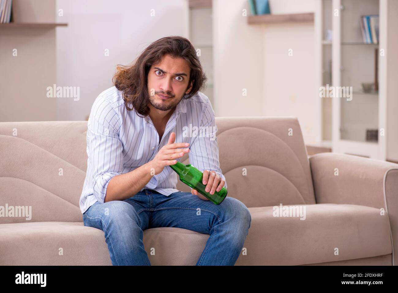 Man drinking alcohol at home Stock Photo - Alamy